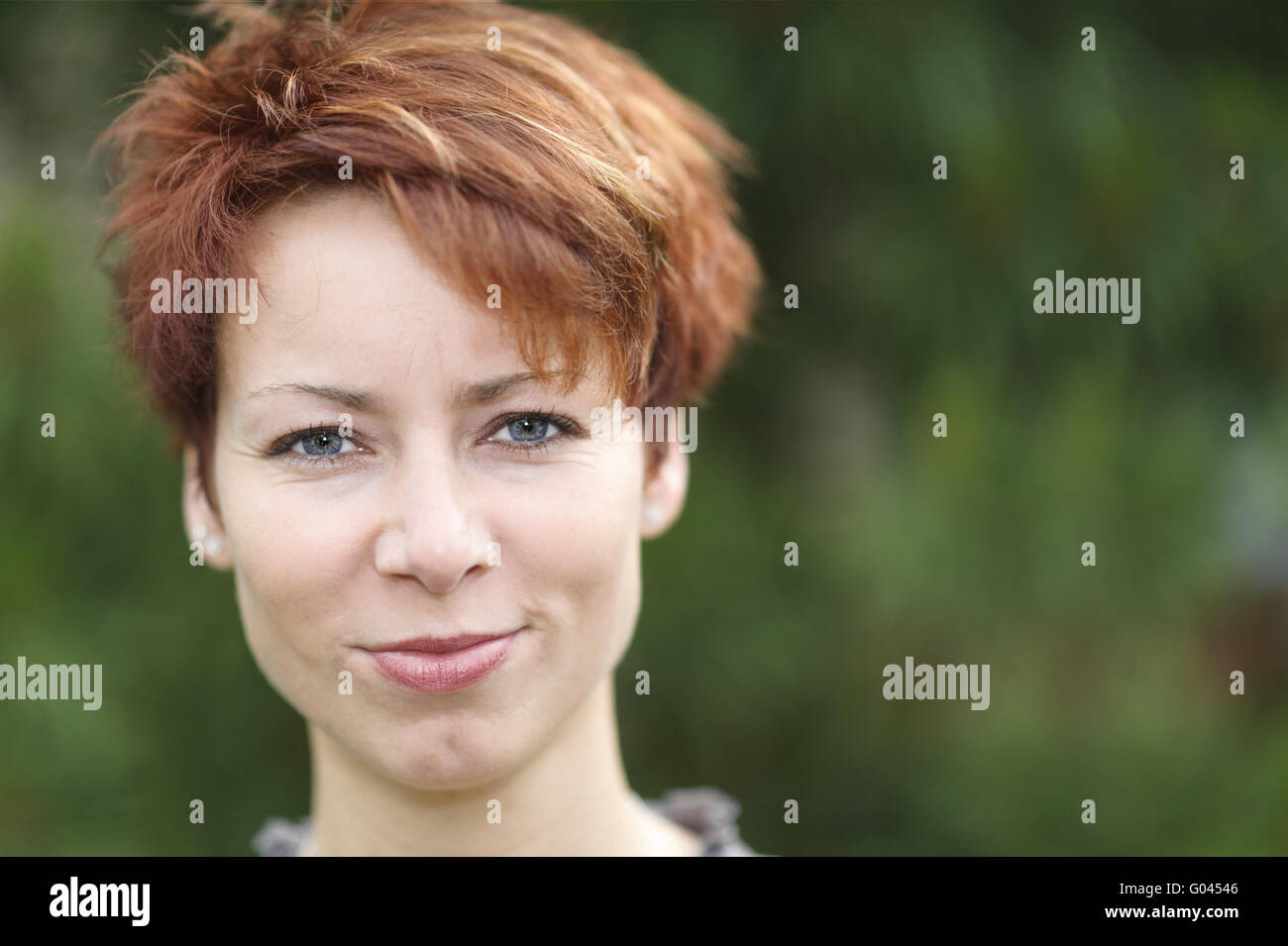 Portrait of a tomboyish young woman with red hair Stock Photo - Alamy