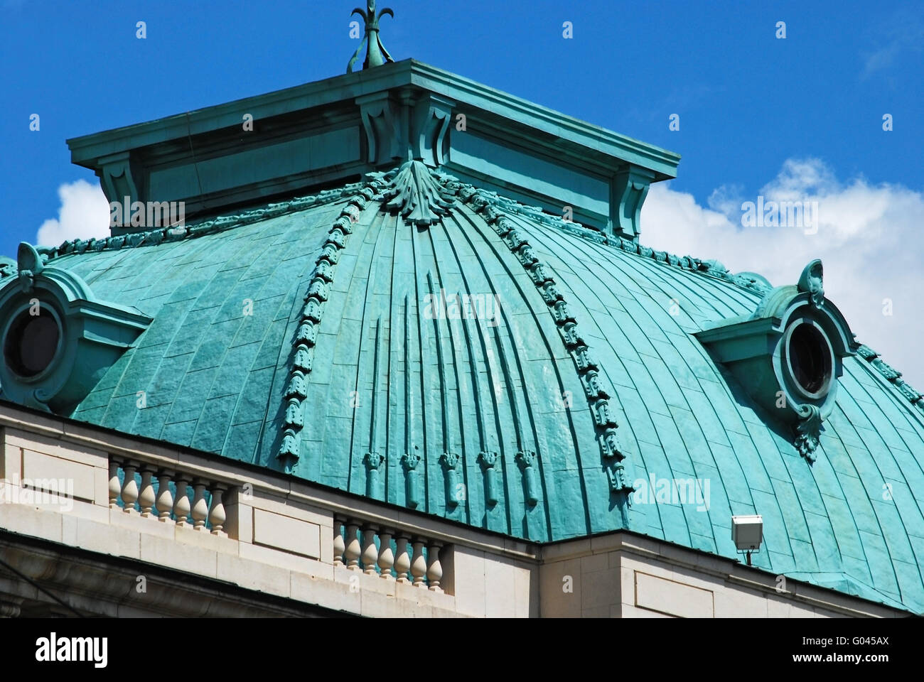 Patina colored old public building top on blue sky Stock Photo - Alamy