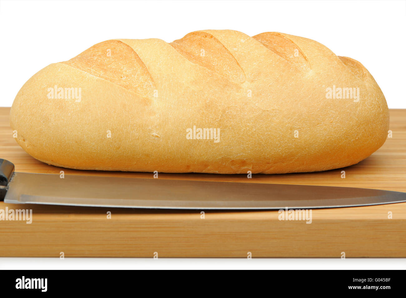 The cut bread on a chopping board with a knife Stock Photo - Alamy