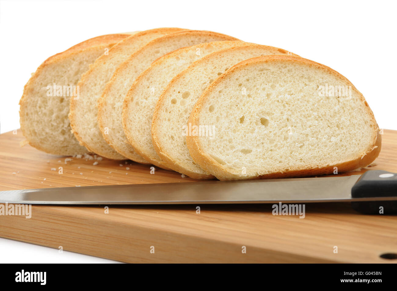 The cut bread on a chopping board with a knife Stock Photo - Alamy