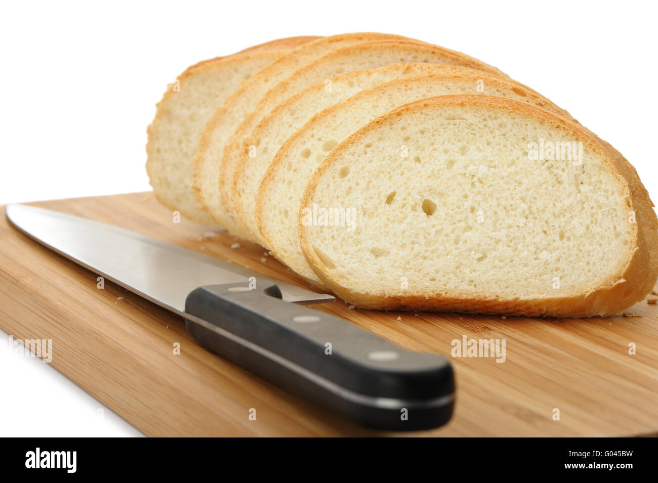 The cut bread on a chopping board with a knife Stock Photo - Alamy
