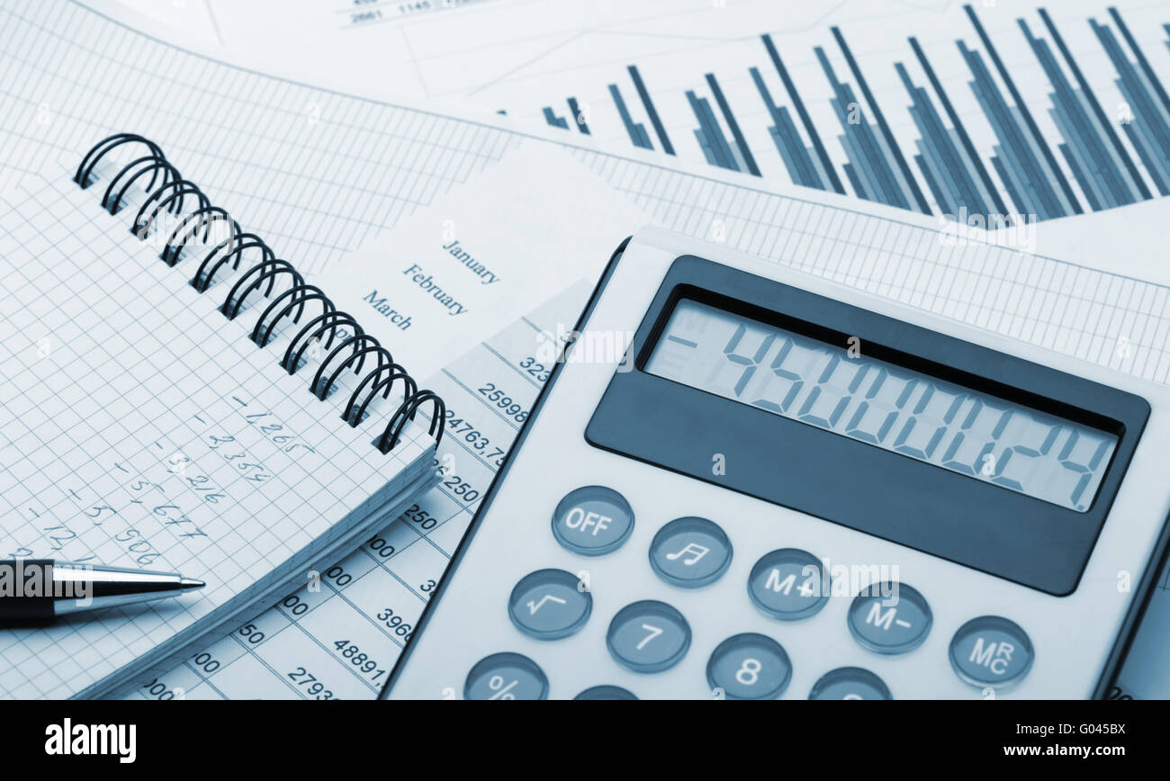 The calculator and the financial report blue toned Stock Photo - Alamy