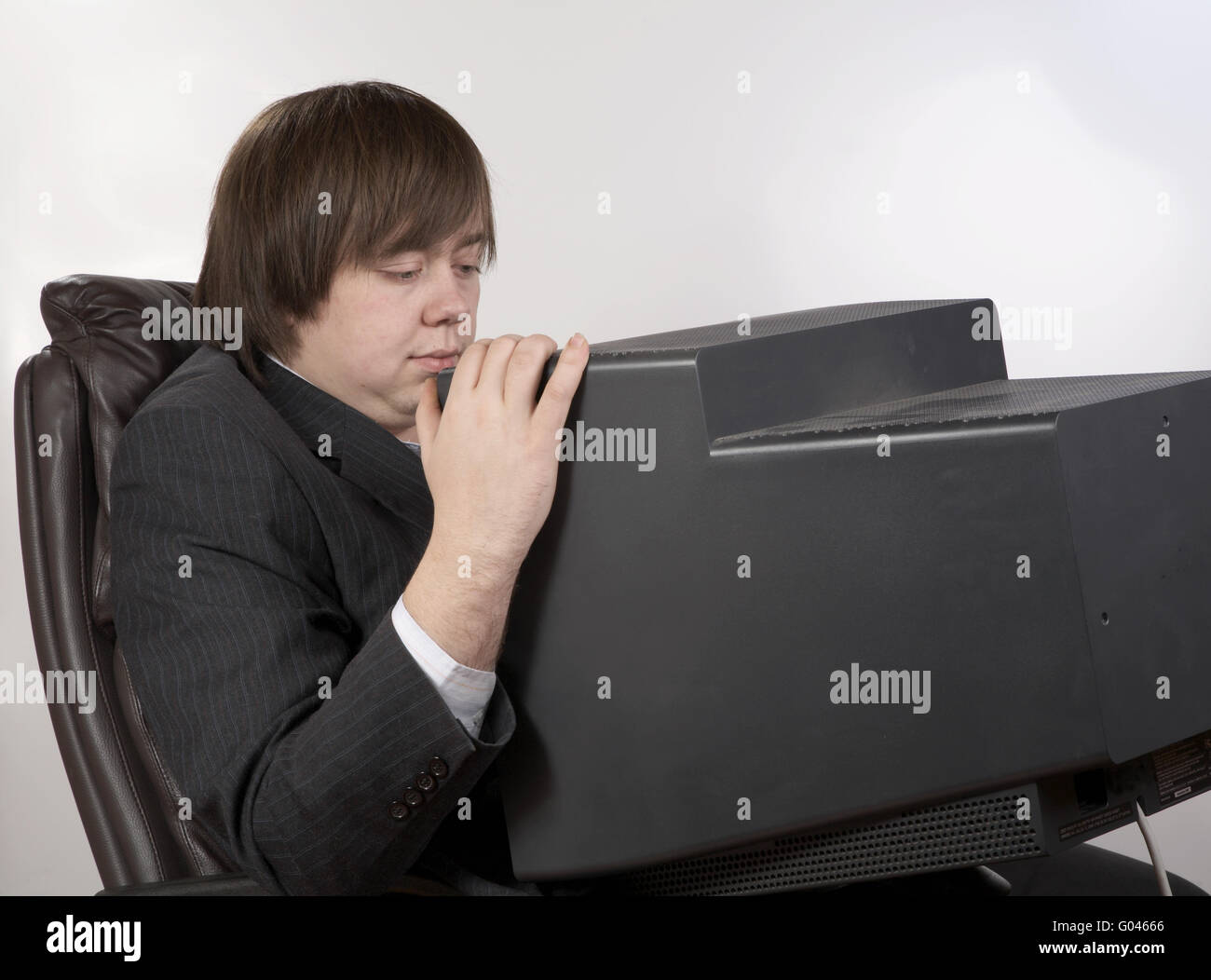The man the holding monitor on a grey background Stock Photo - Alamy
