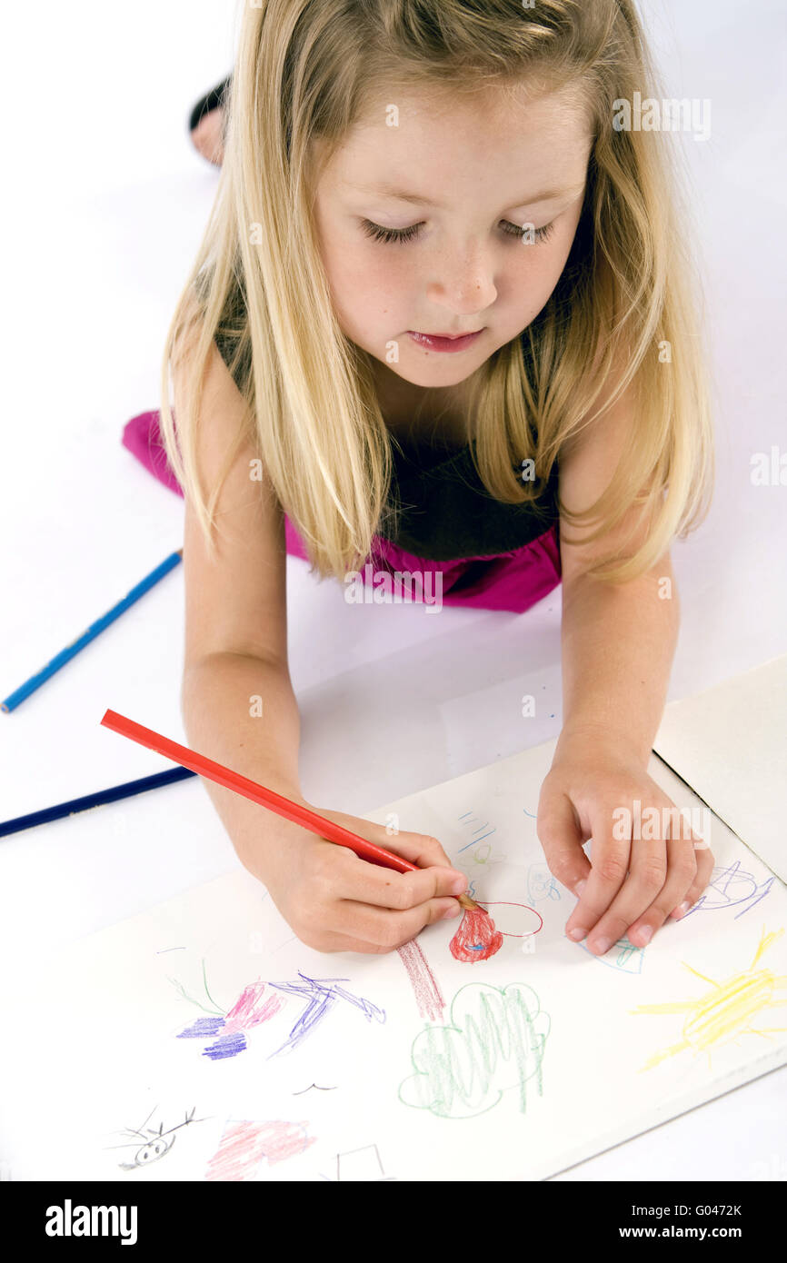 Little girl drawing on paper Stock Photo - Alamy