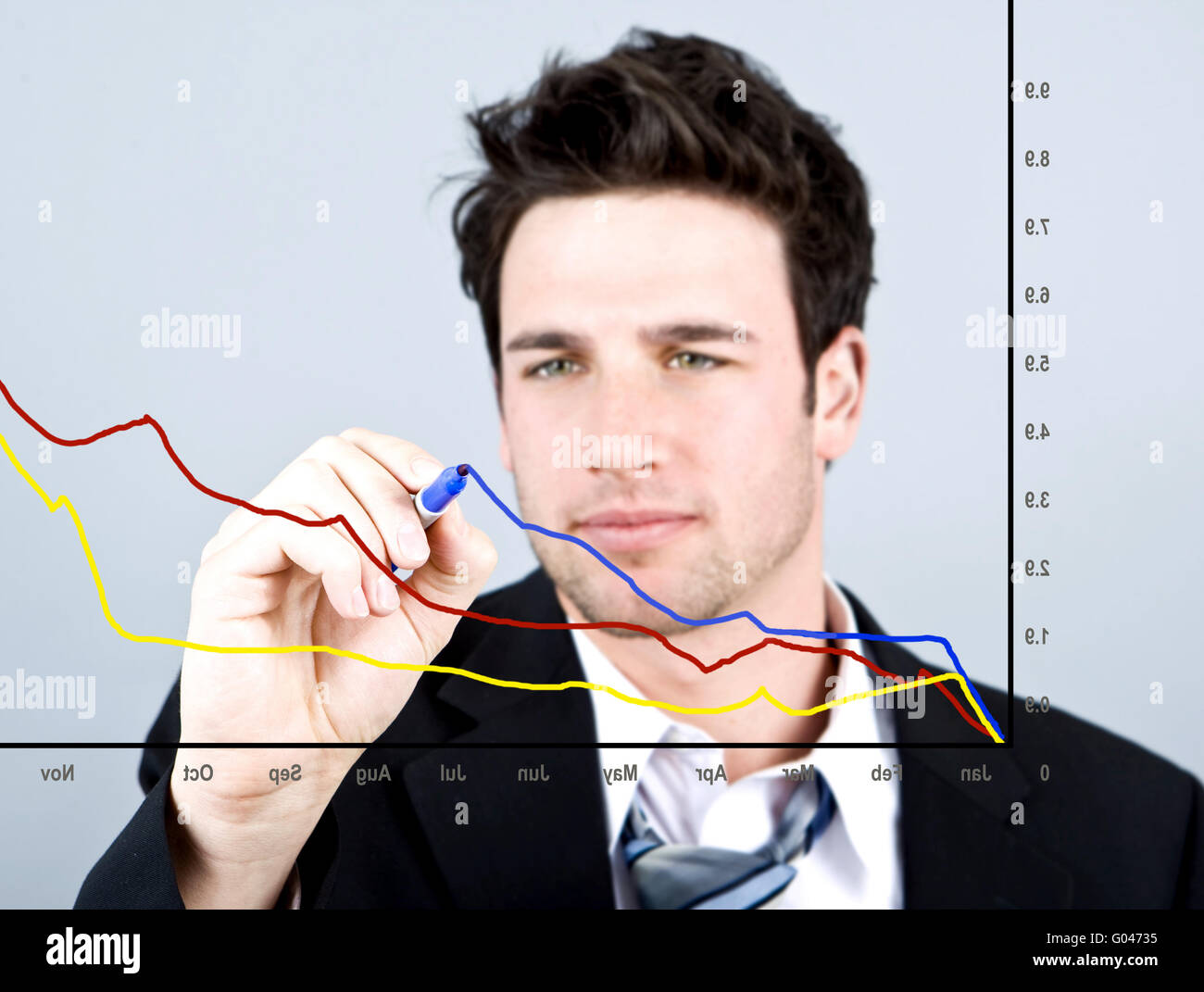 Attractive business man drawing on a graph Stock Photo - Alamy