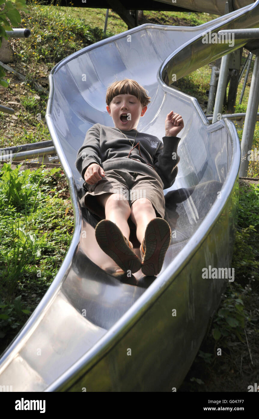 Boy on slide, chude, sliding, to slide, playground Stock Photo - Alamy