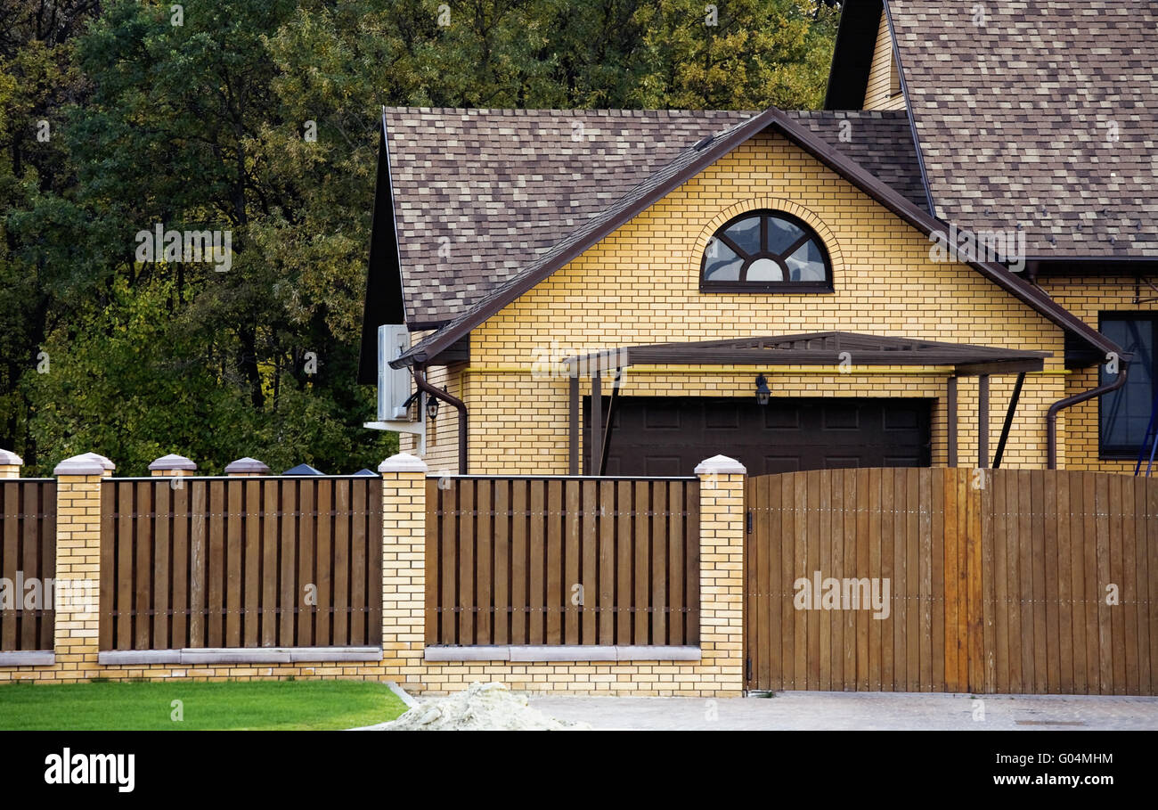brick house and fence in an environment of vegetat Stock Photo - Alamy