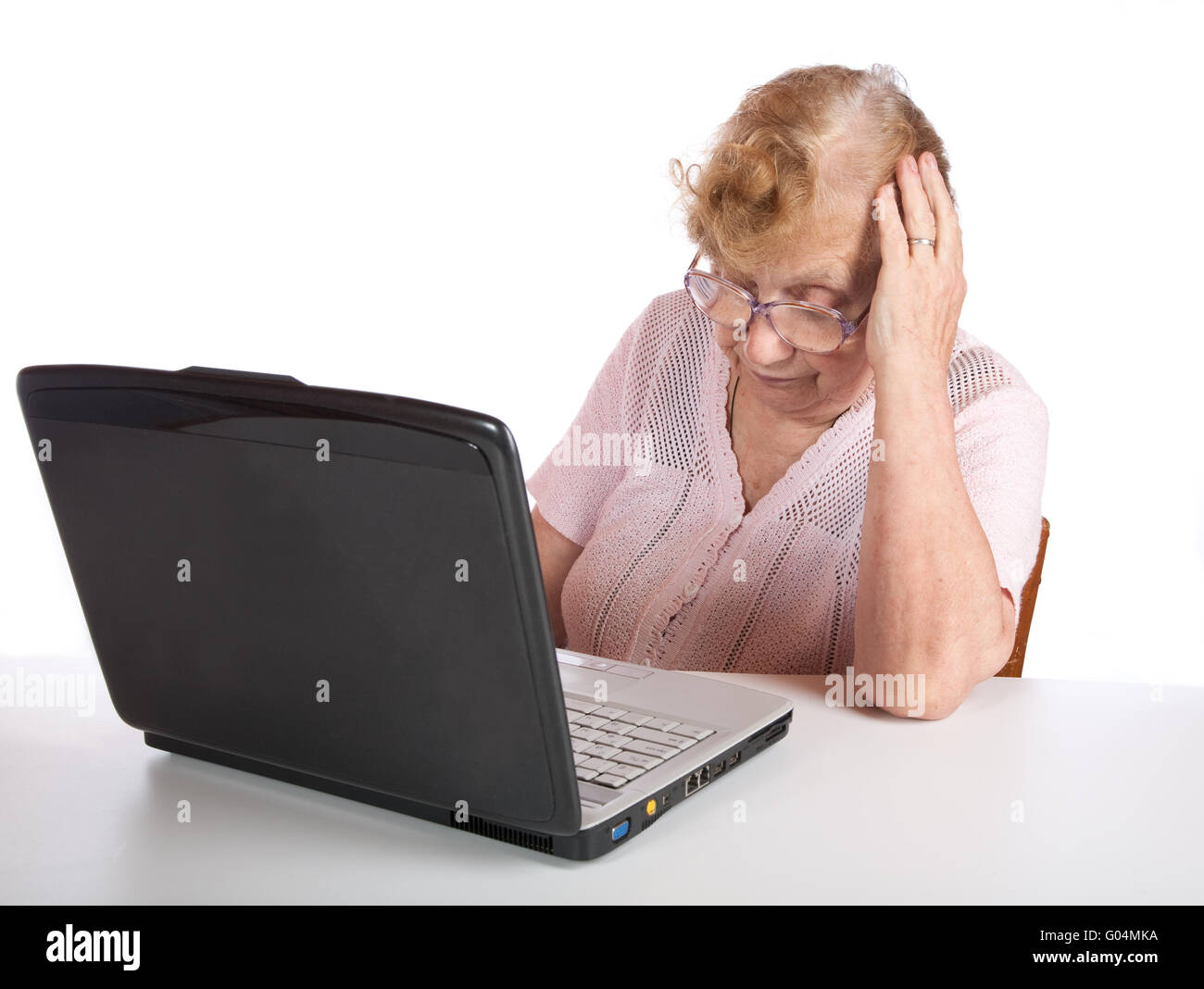The old woman in glasses looks at the screen notebook Stock Photo - Alamy