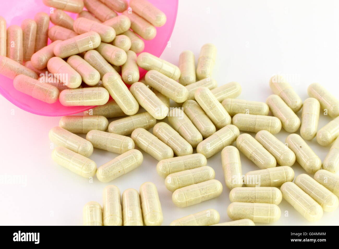 Spilled prescription capsules from pink round bowl Stock Photo - Alamy