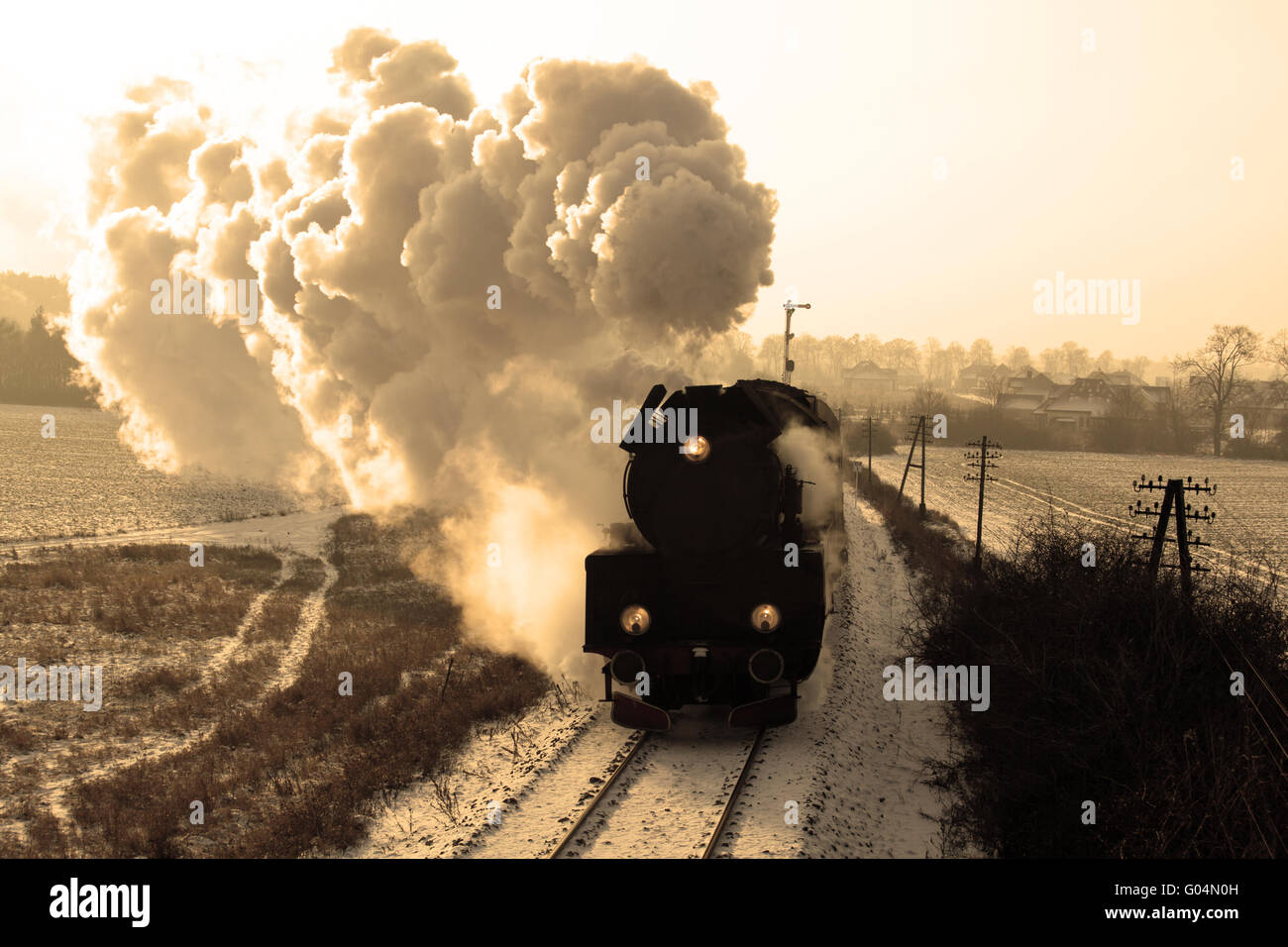 Vintage steam train starting from the station Stock Photo - Alamy