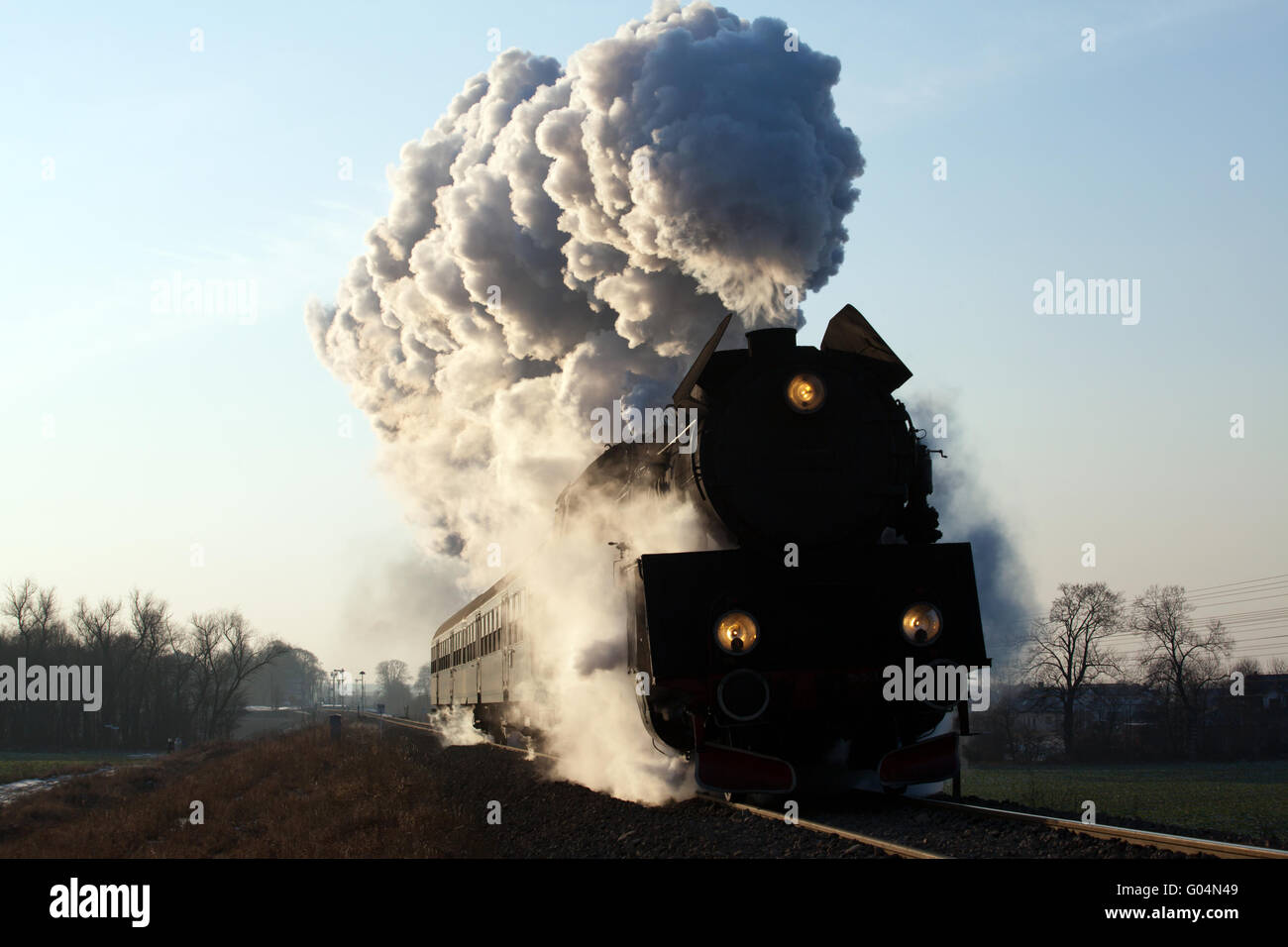 Vintage steam train starting from the station Stock Photo - Alamy