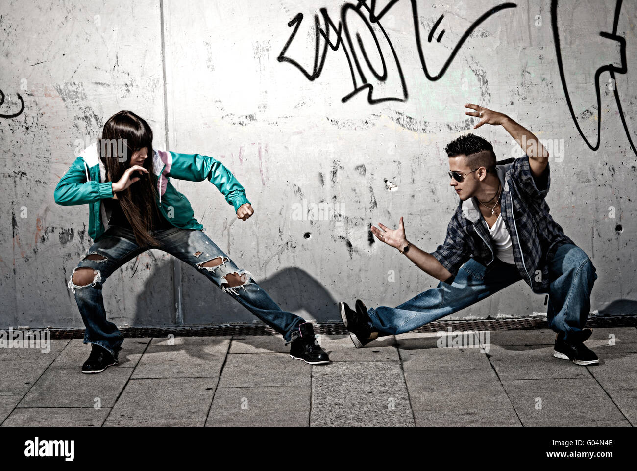 Young urban couple dancers hip hop dancing fight acting urban scene ...