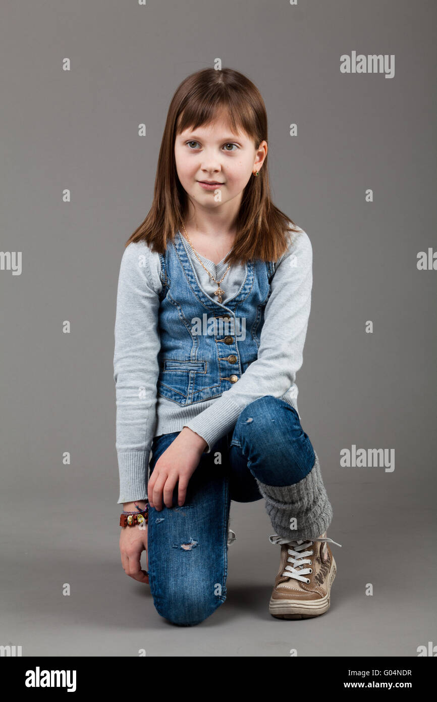 young happy girl. little girl on a gray backgroun Stock Photo - Alamy