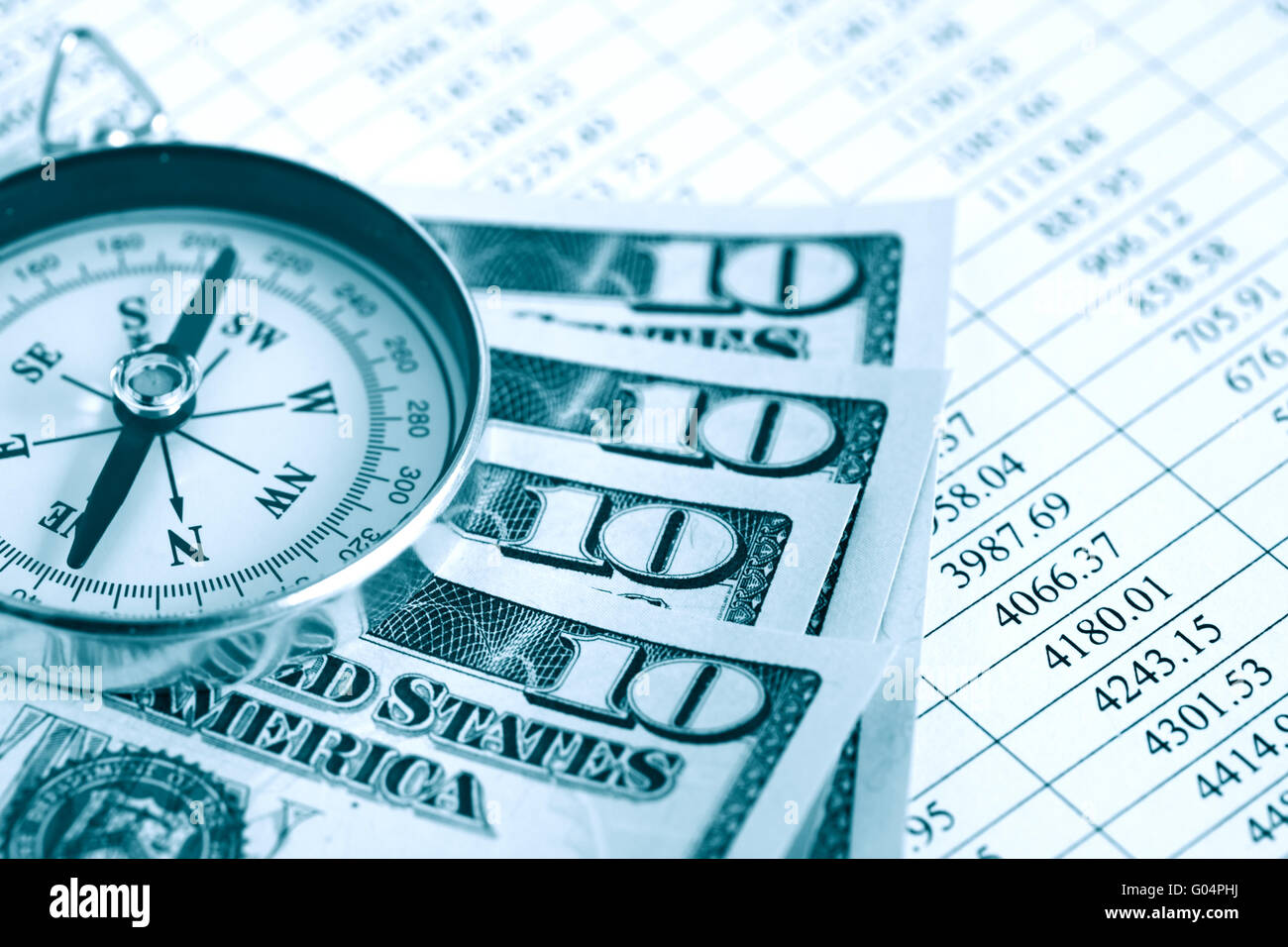 Dollar rate. Closeup of compass and dollar bank notes on paper list ...