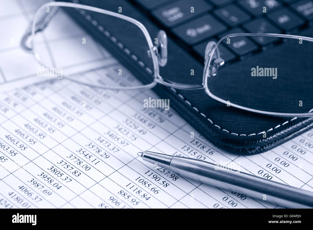Closeup of pen and spectacles near laptop Stock Photo - Alamy