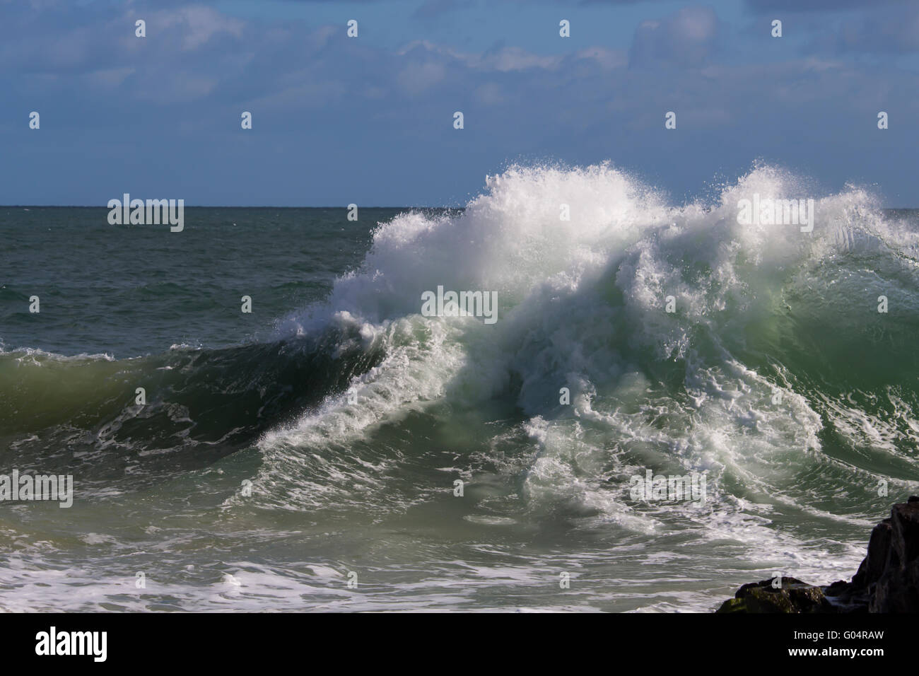Backwash from high Indian Ocean waves breaking on the dark basalt rocks ...