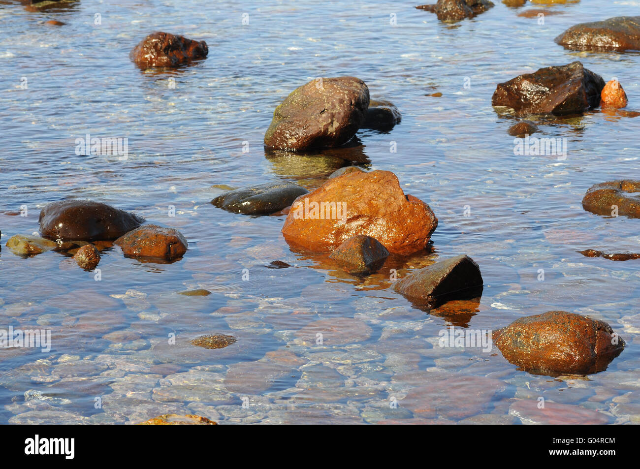 Stones in shallow water Stock Photo - Alamy