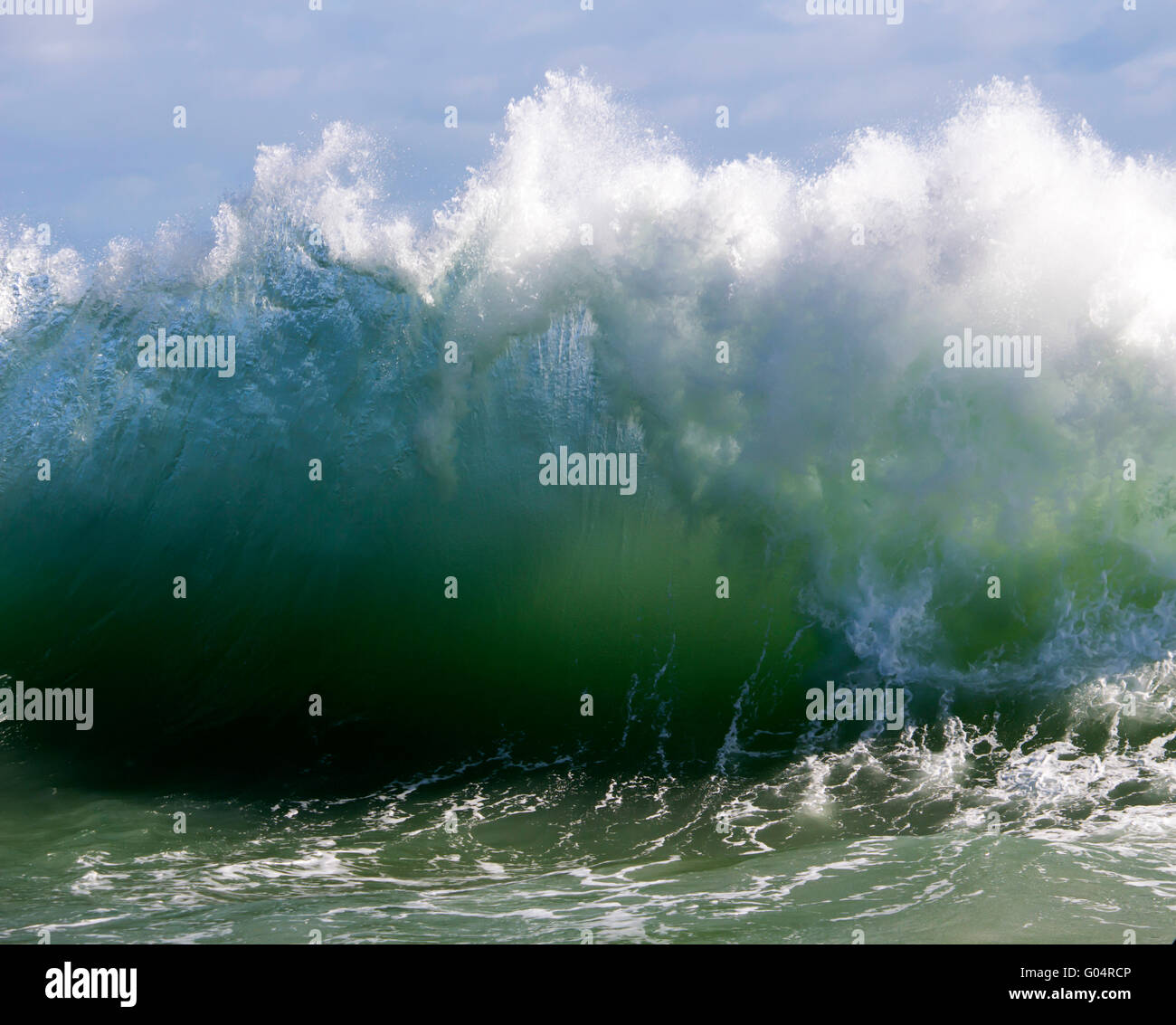 Backwash from high Indian Ocean waves breaking on the dark basalt rocks ...