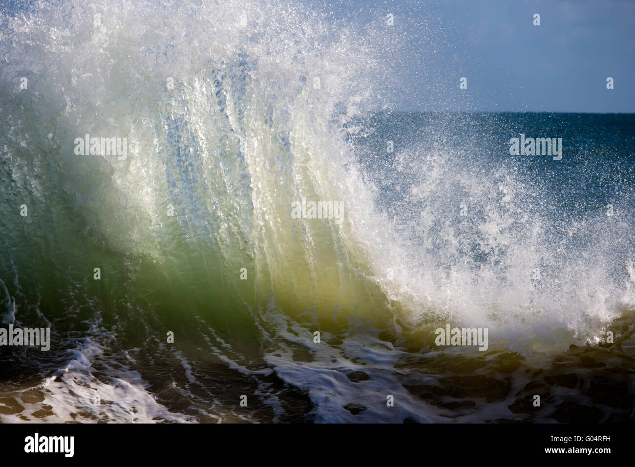 Backwash from high Indian Ocean waves breaking on the dark basalt rocks ...