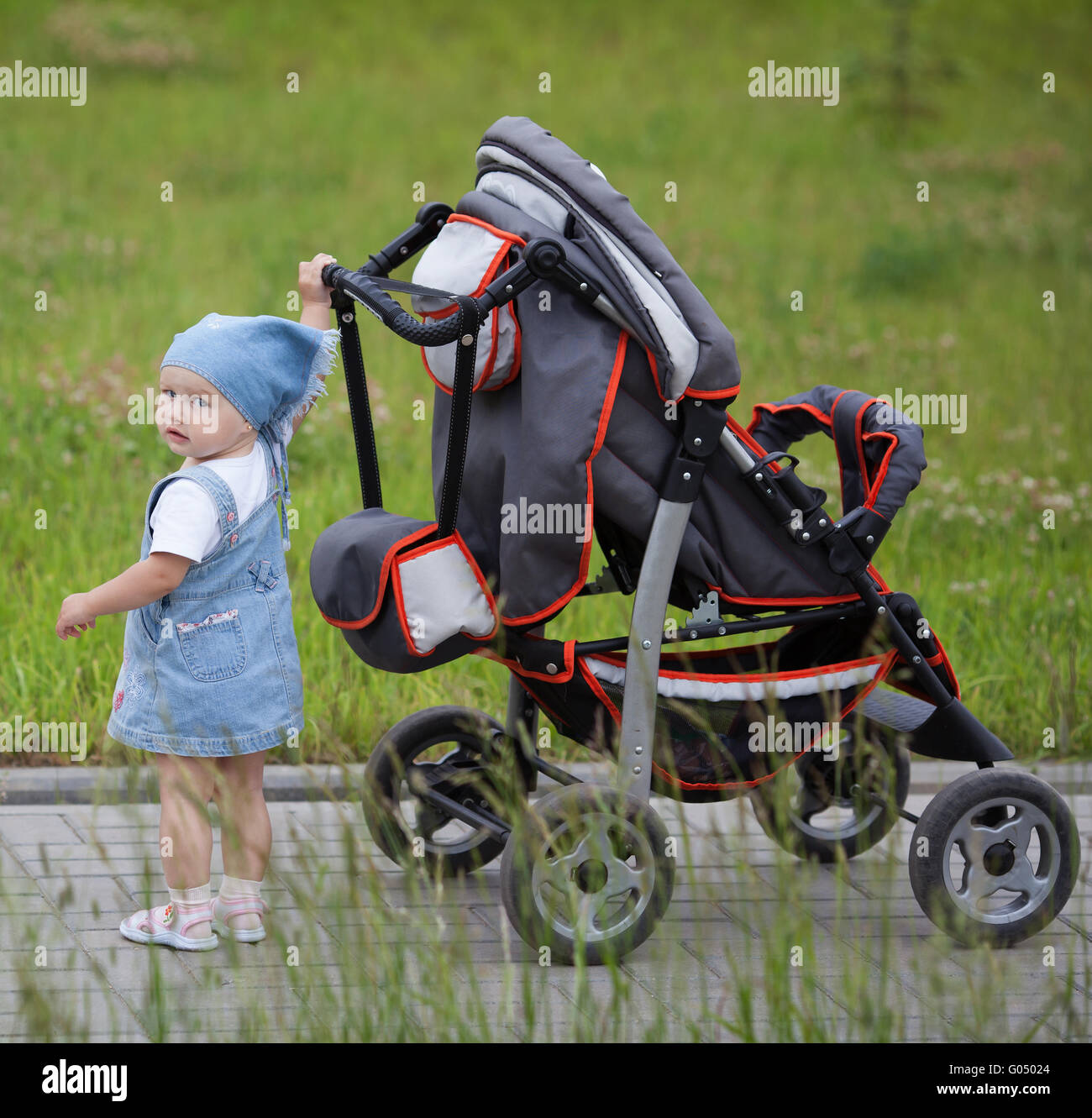 little funny girl with baby carriage Stock Photo - Alamy