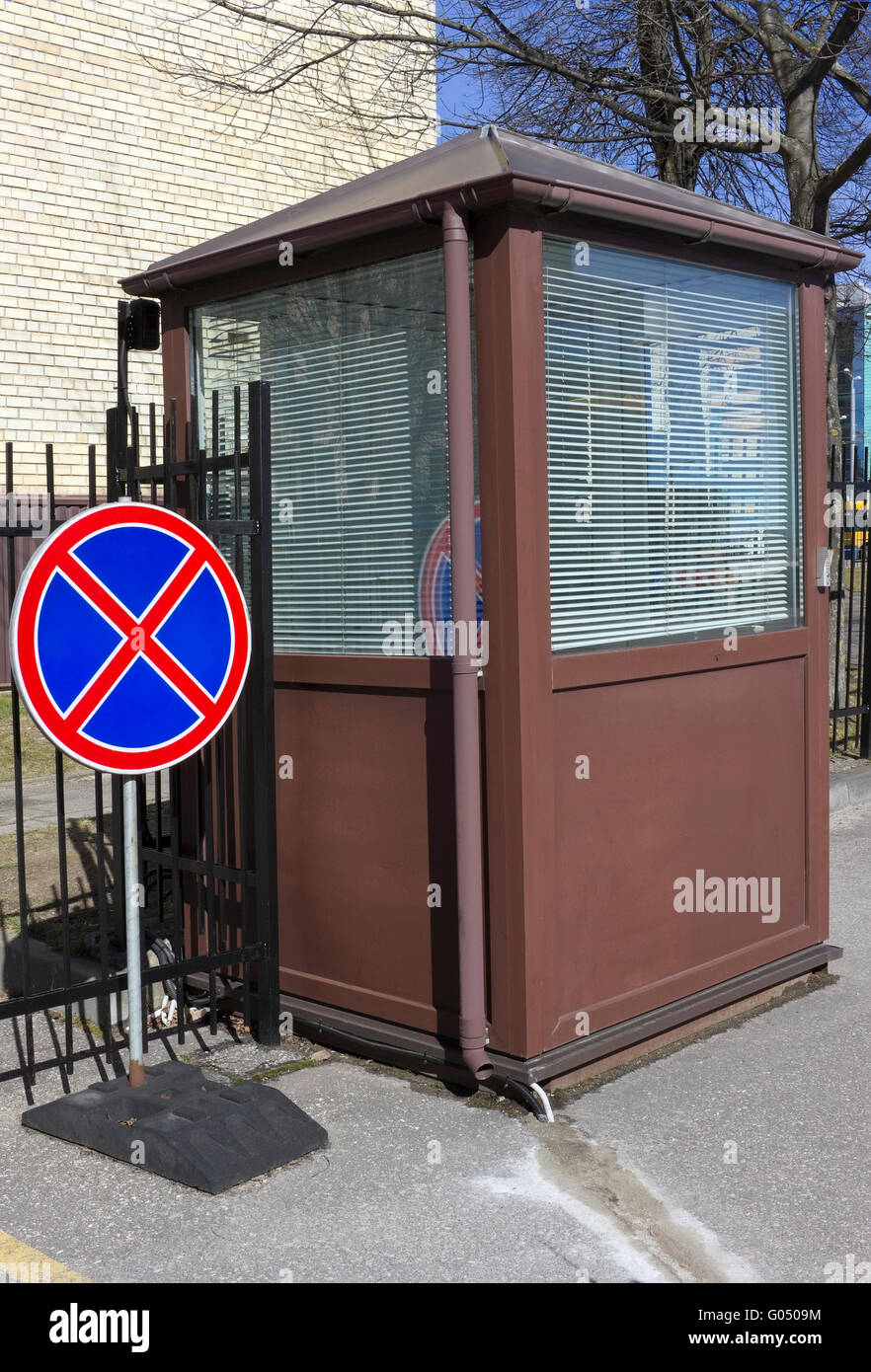 Road sign "The stop is forbidden" near the small brown box of the ...