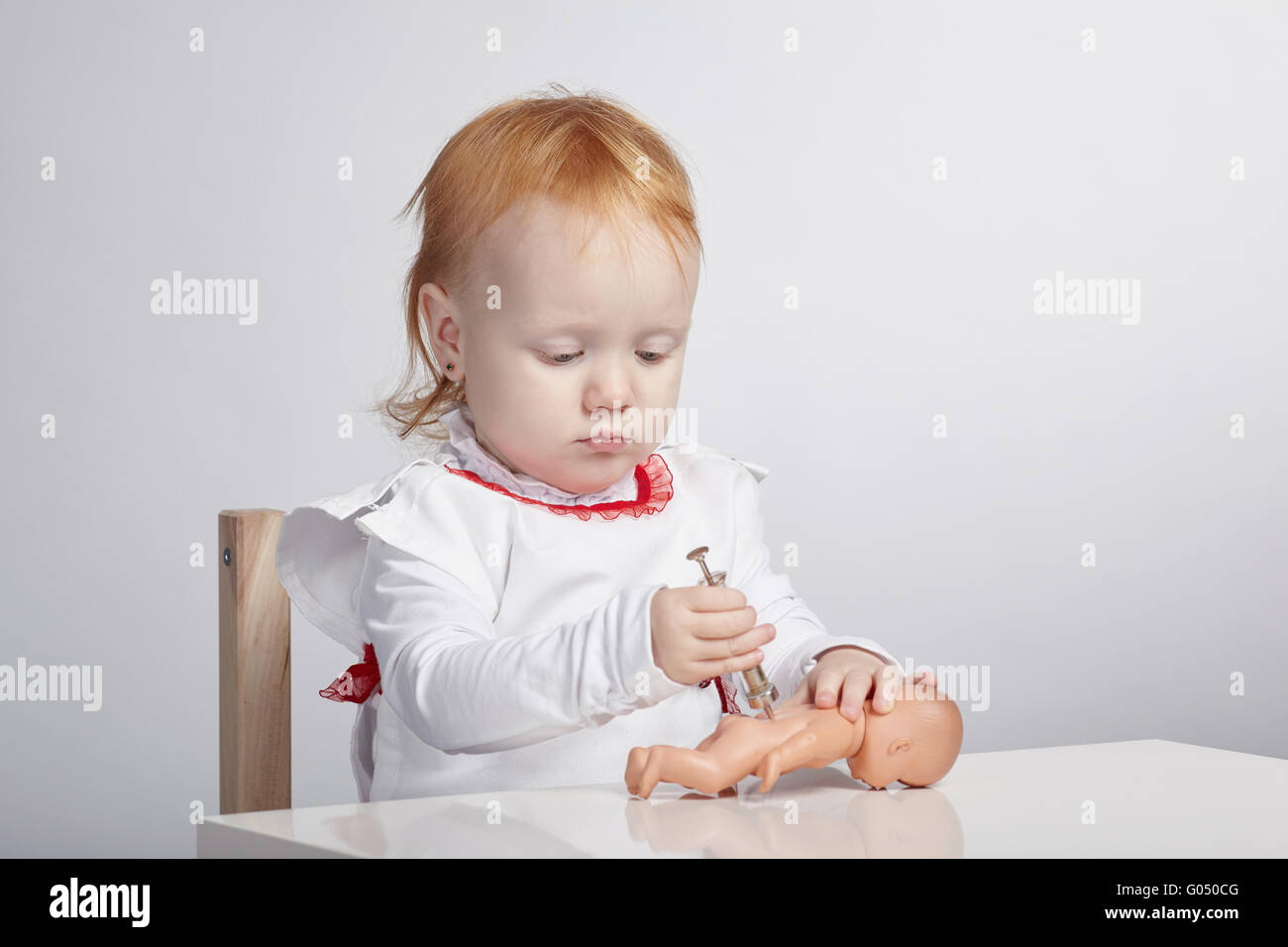 Sick child playing with doll hi-res stock photography and images - Alamy