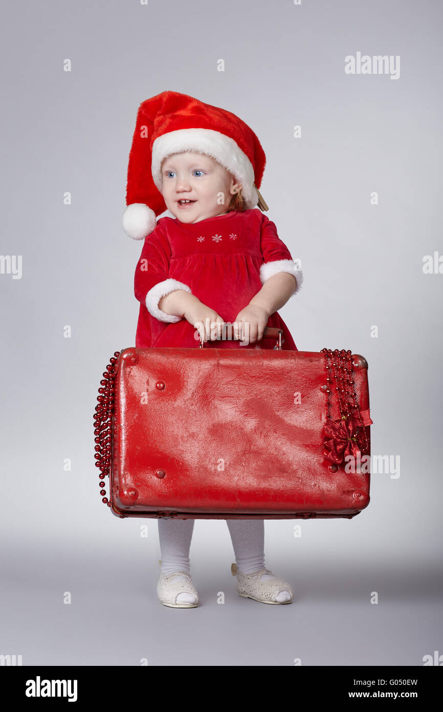 little cute girl with christmas suitcase Stock Photo - Alamy