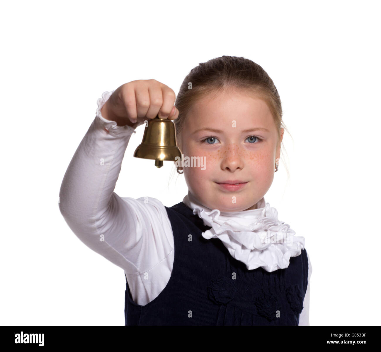 Young school girl ringing a golden bell on white background Stock Photo ...