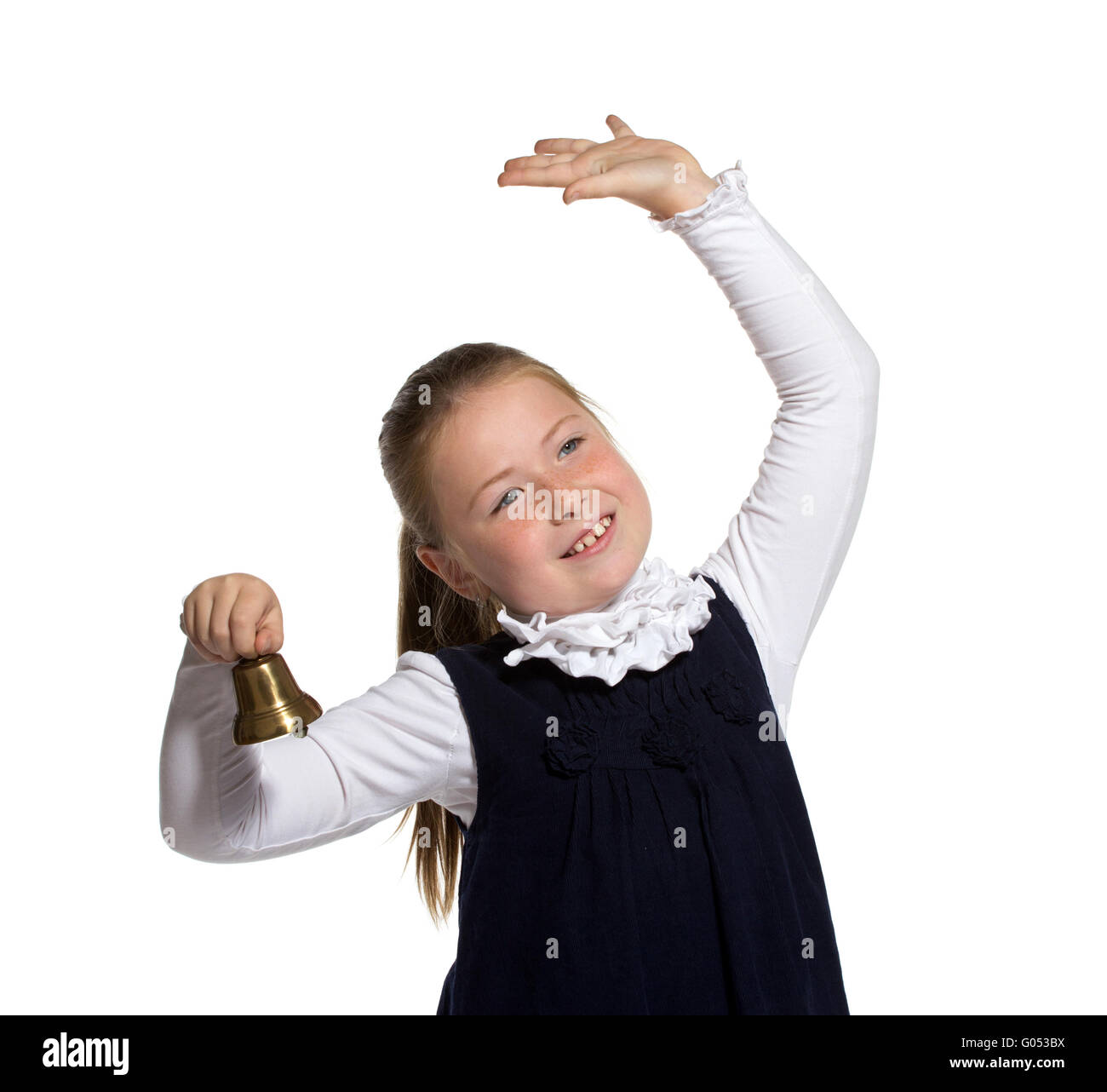 Young school girl ringing a golden bell on white background Stock Photo ...