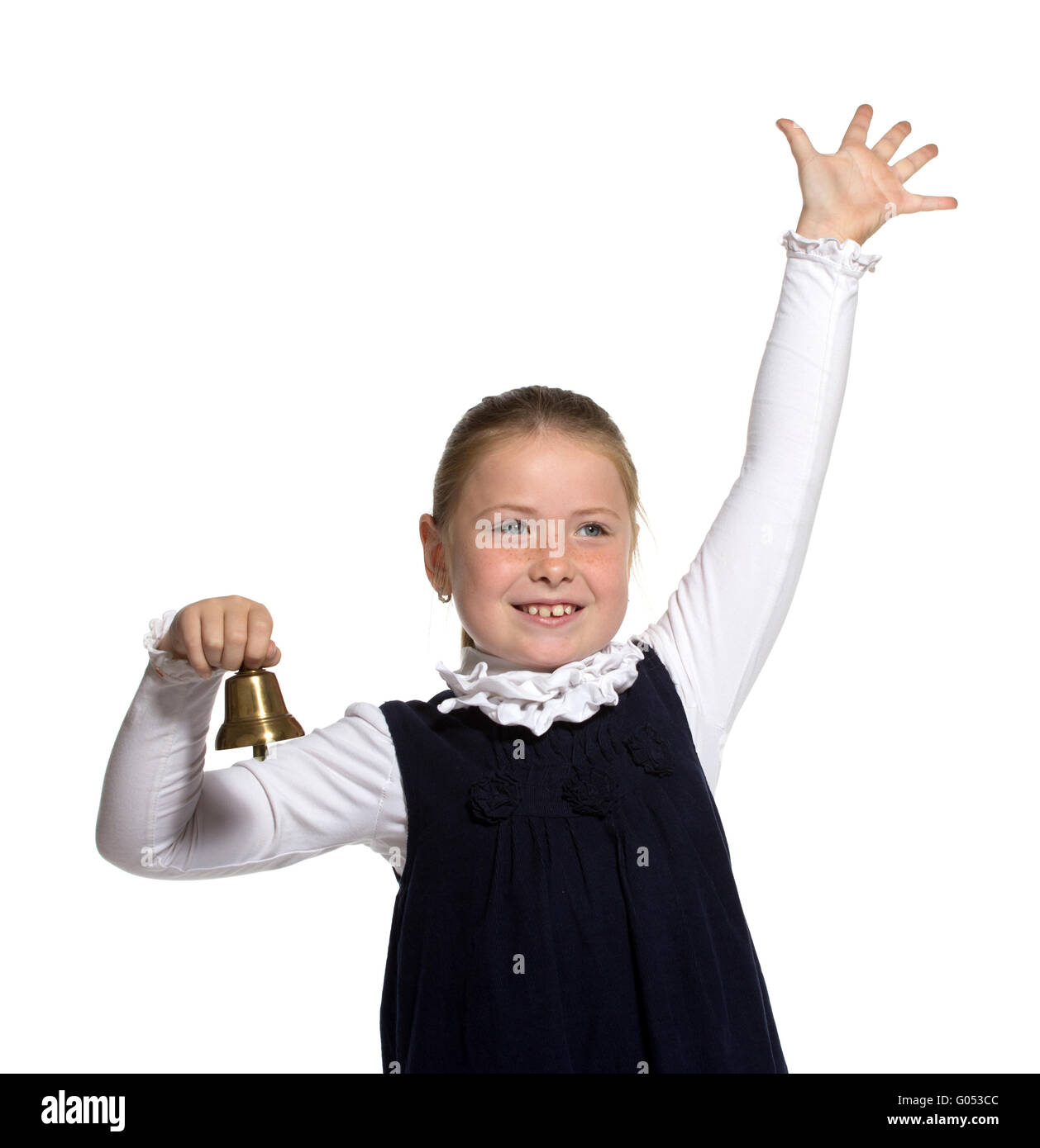 Young school girl ringing a golden bell on white background Stock Photo ...