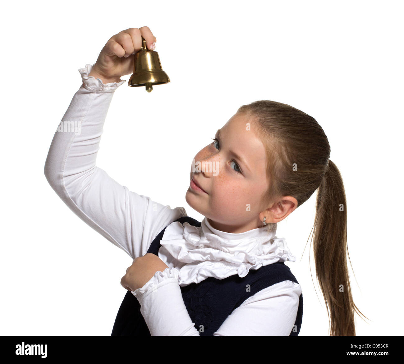 Young school girl ringing a golden bell on white background Stock Photo ...
