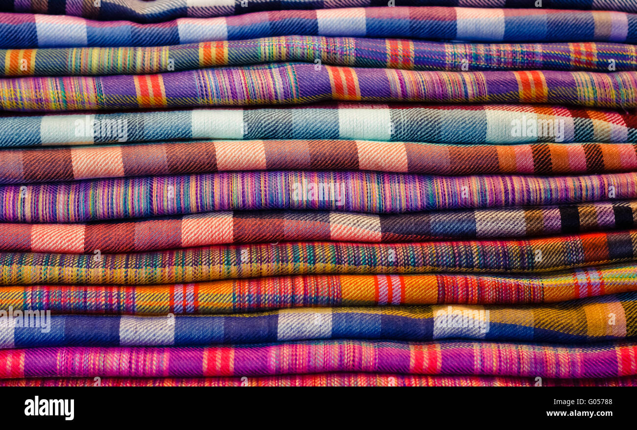 Stack of colorful fabrics at market Stock Photo - Alamy