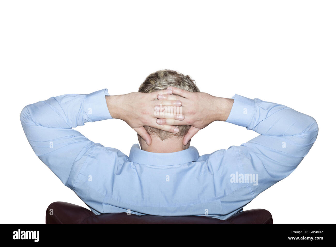 Man sitting on a chair with folded arms behind th Stock Photo - Alamy