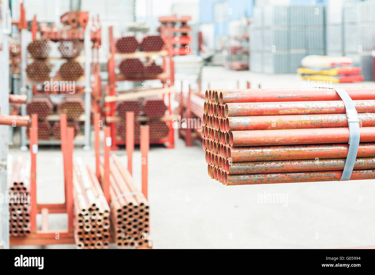 Stack of steel pipes for scaffolding in warehouse Stock Photo - Alamy