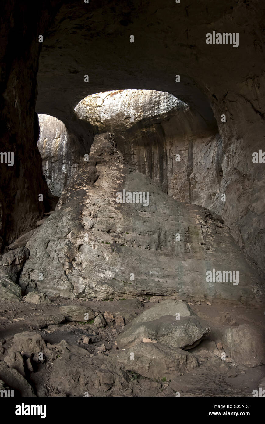 Big cave inside with hole light on ceiling Stock Photo - Alamy