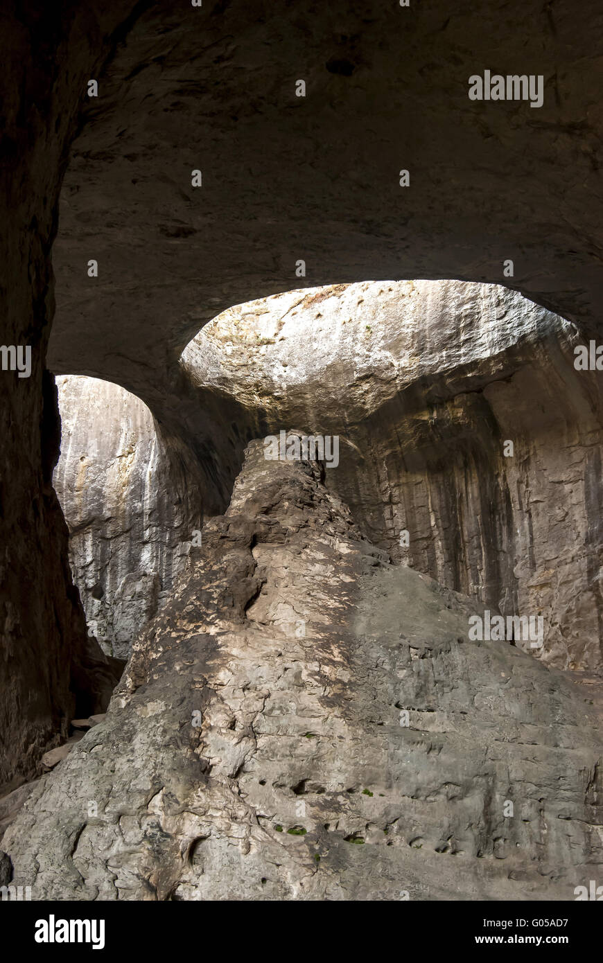 Big cave inside with hole light on ceiling Stock Photo - Alamy