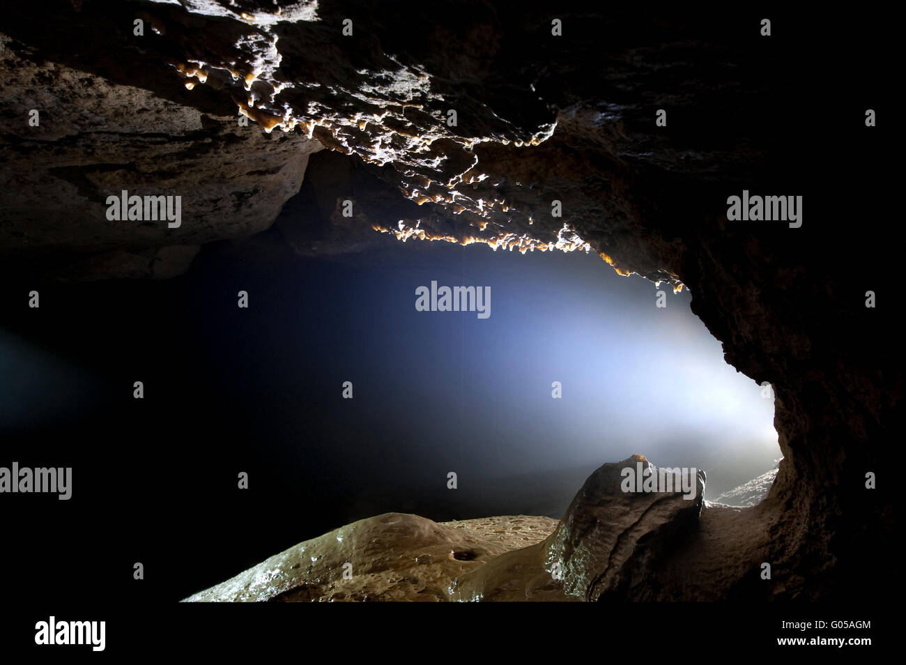 light at the entrance of a dark cave Stock Photo - Alamy