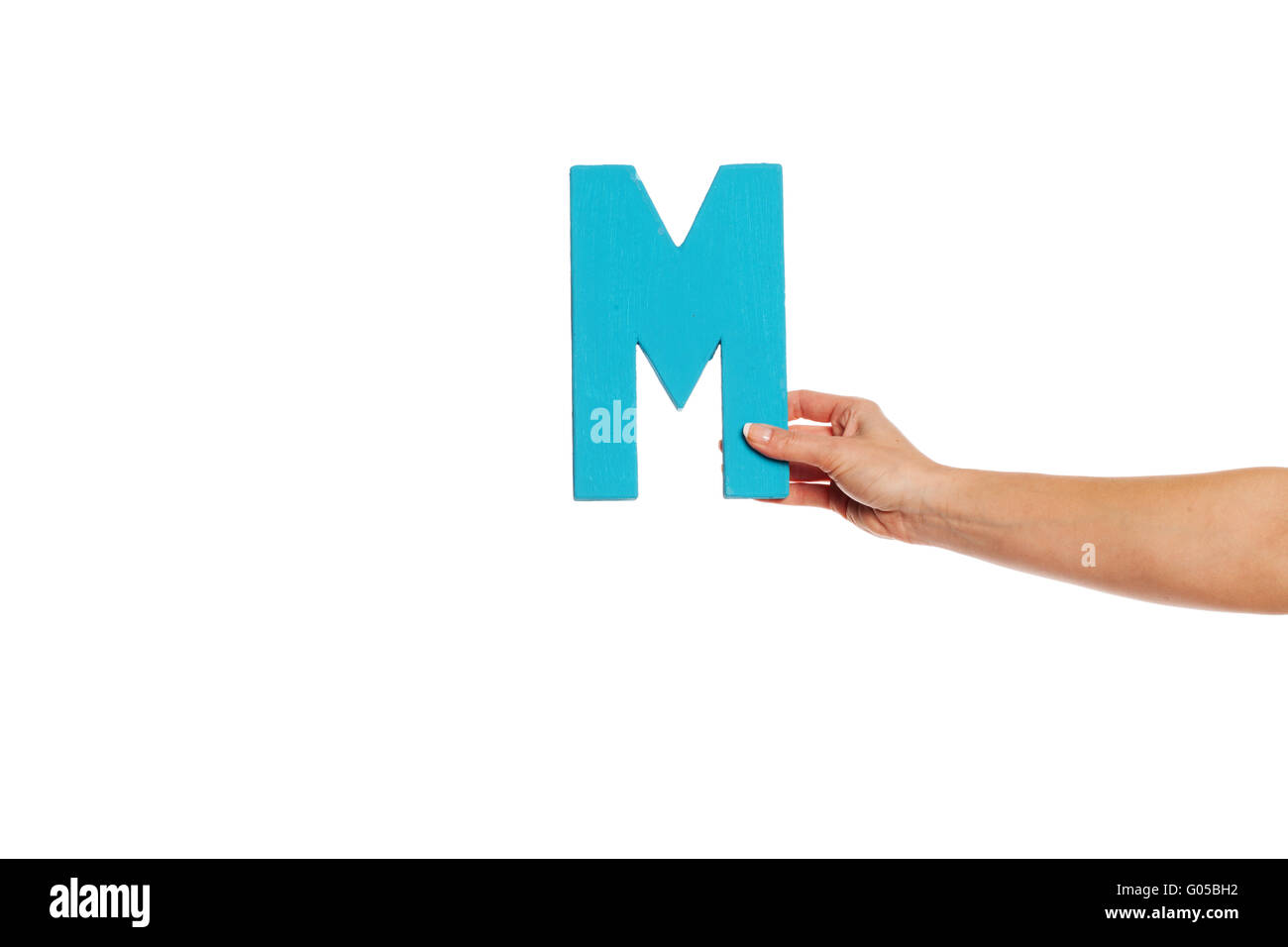 hand holding up the letter M from the right Stock Photo - Alamy