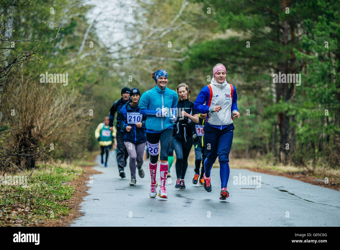 group of young girls athletes running along road during Half marathon ...