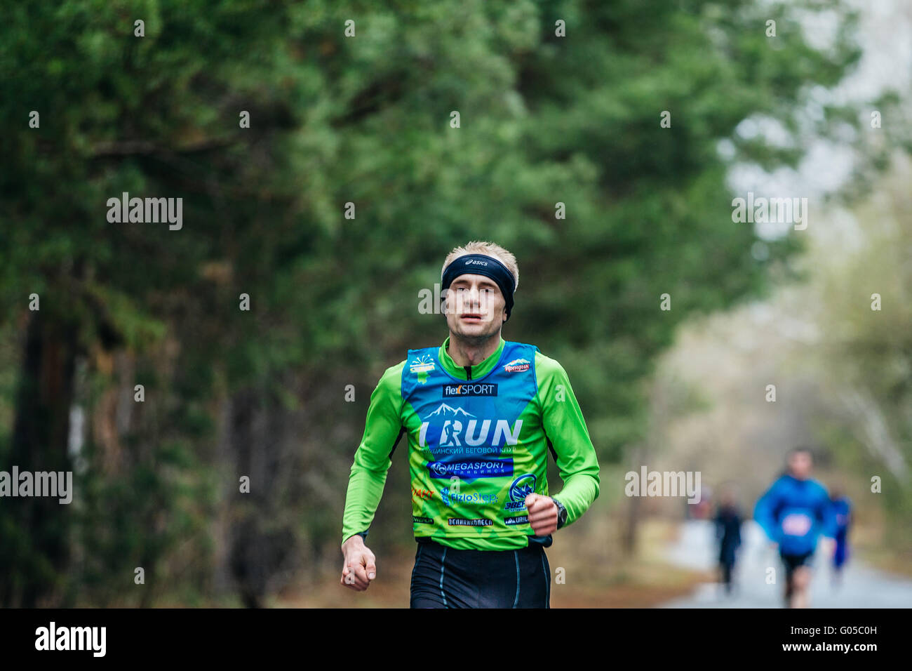 single young male runner in Park during Half marathon in woods Stock ...