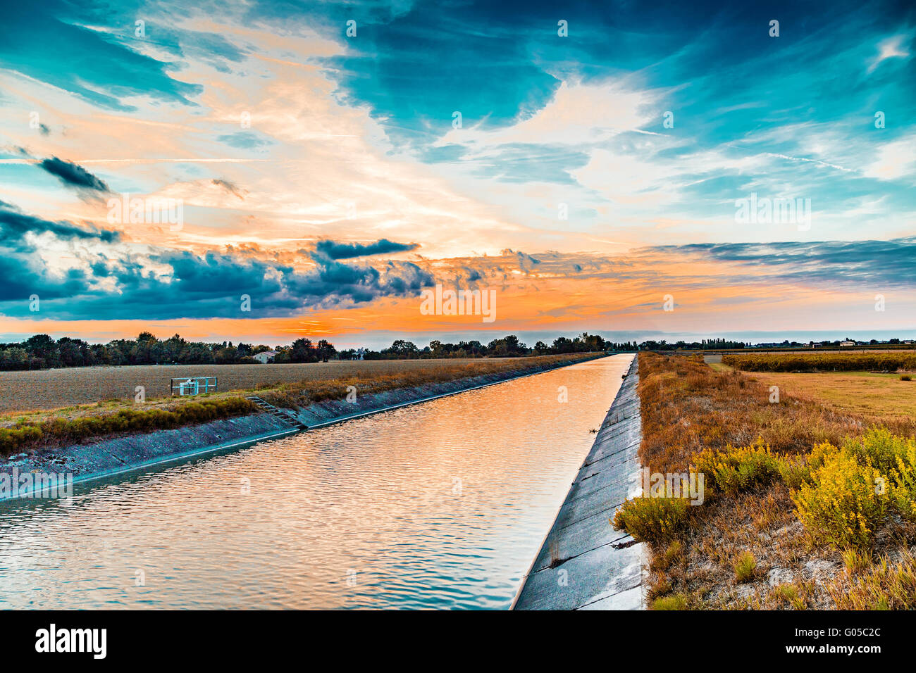 Channel to divert river water for irrigation of cultivated fields Stock ...