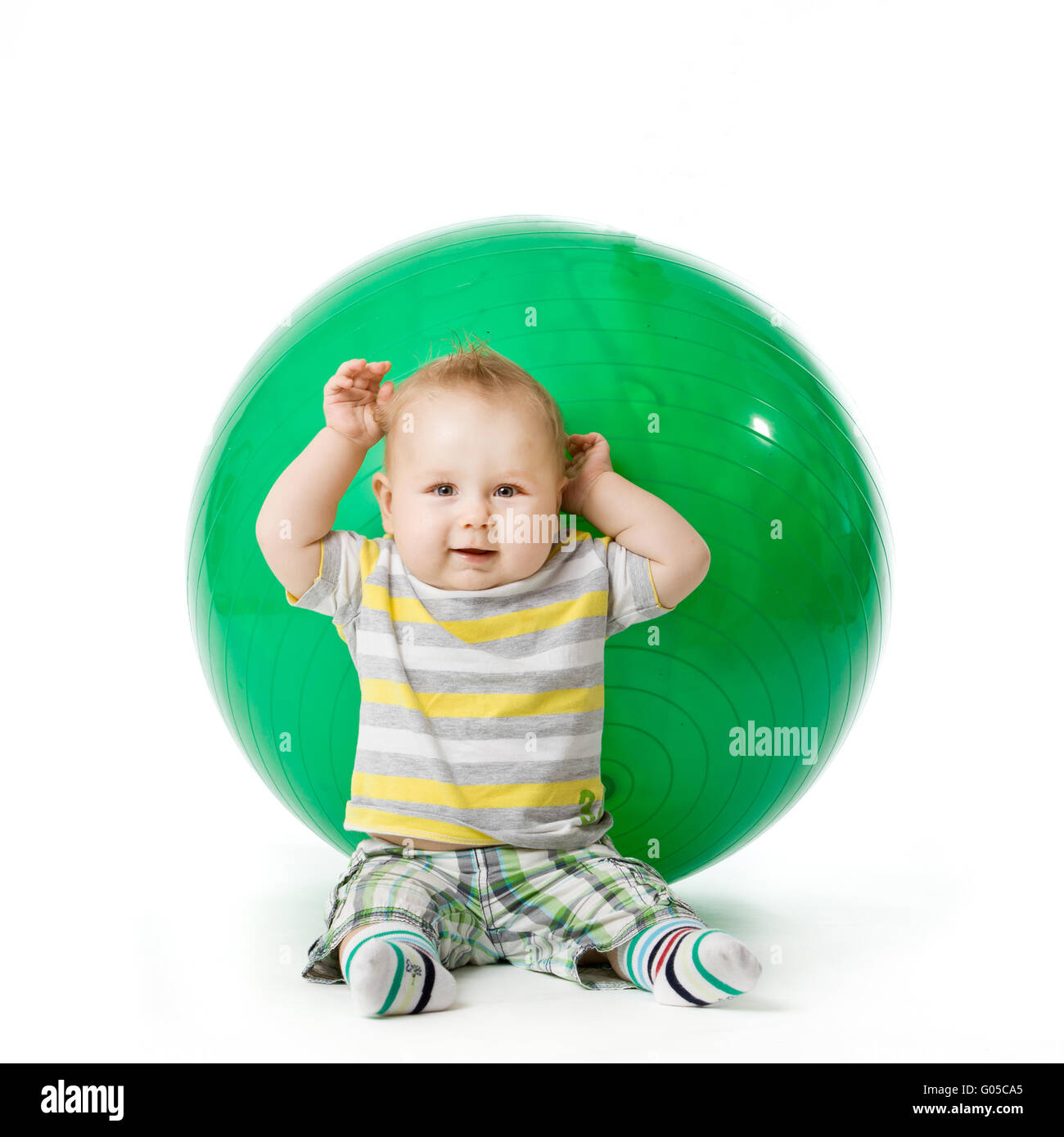 sweet small baby with fitness ball on a white back Stock Photo - Alamy