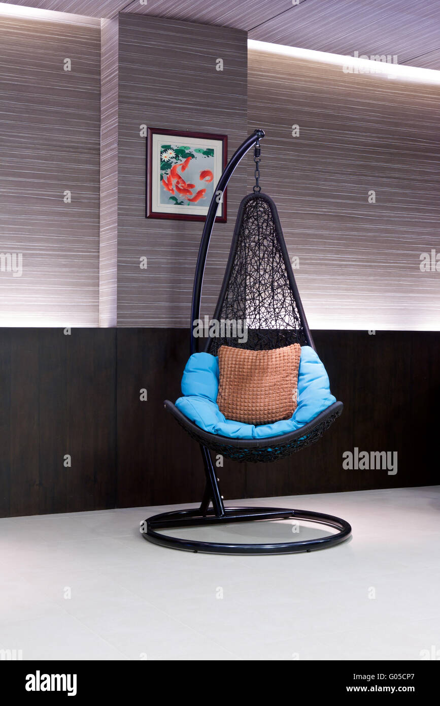 chair hanging on a chain in the hotel lobby Stock Photo - Alamy