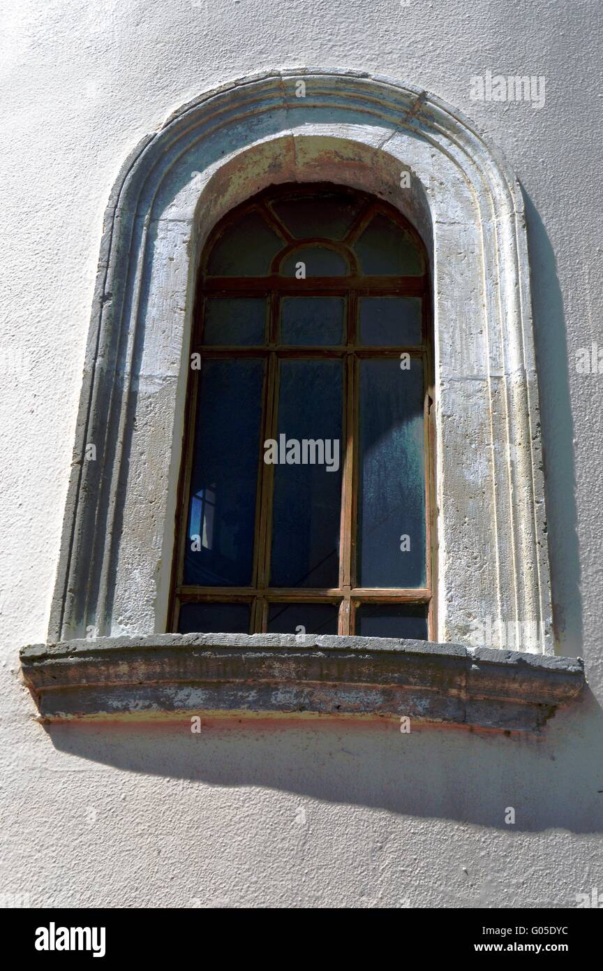 A window on a tower with an arch Stock Photo - Alamy