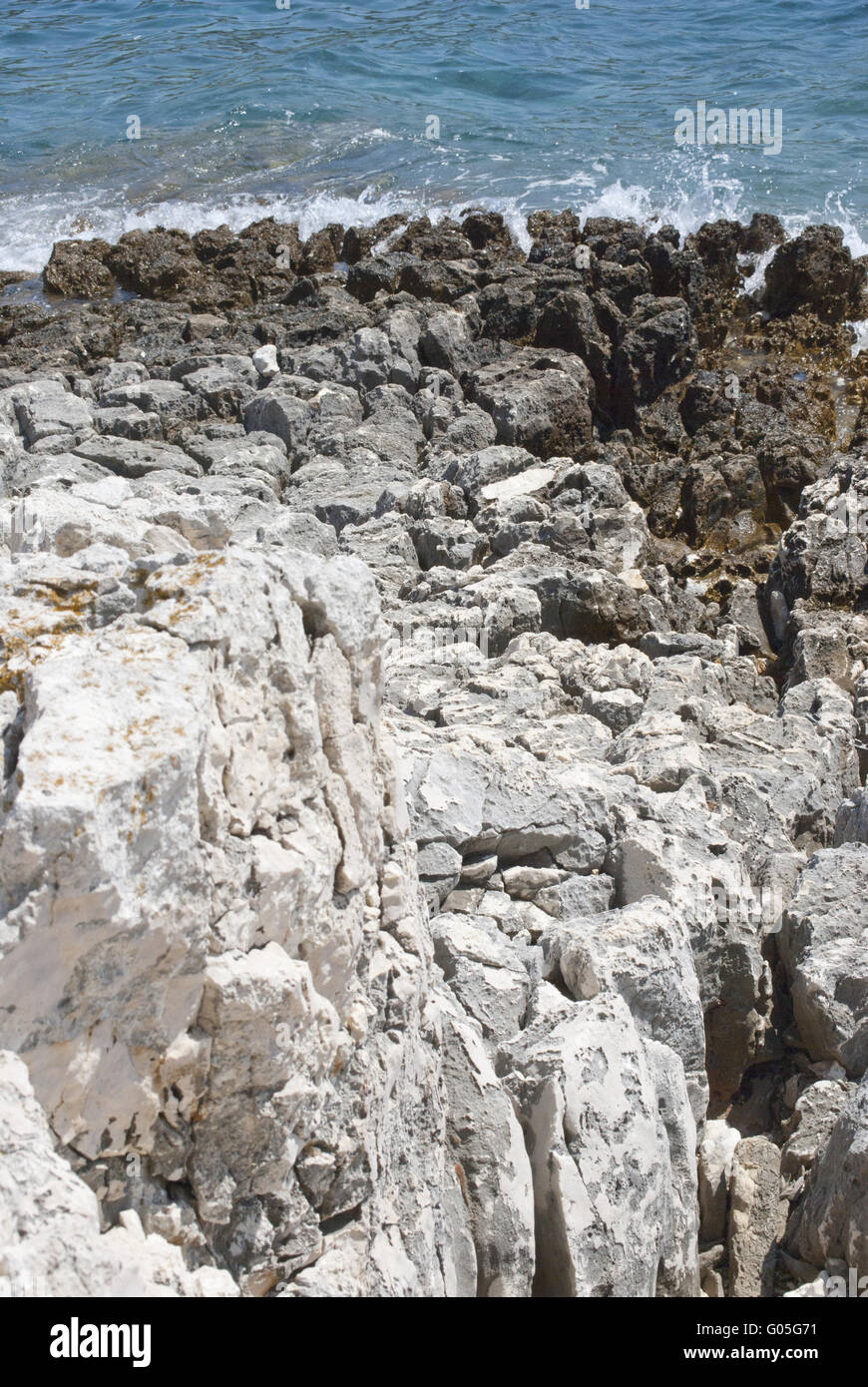 rocky beach and sharp rocks Stock Photo - Alamy