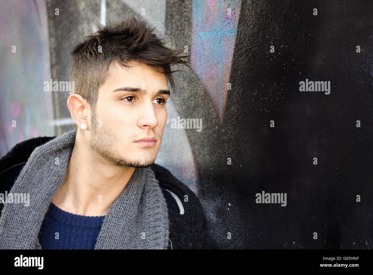 Handsome young man looking to a side Stock Photo - Alamy