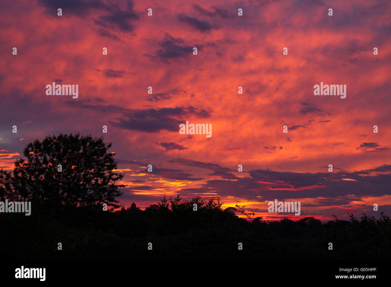 Fiery red sky during sunset one summer evening Stock Photo - Alamy