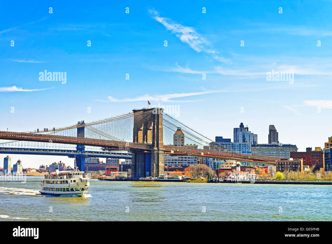 Ferry boat and and Brooklyn bridge across East River, New York, USA ...