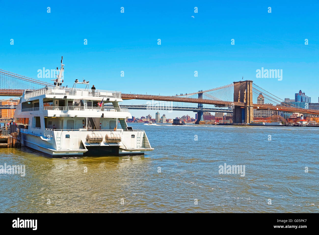 Ferry and and Brooklyn bridge across East River, New York, USA ...