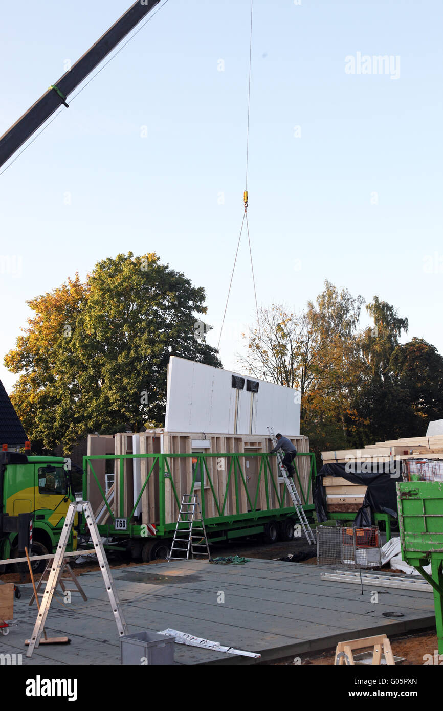 Crane lifting a section of a prefabricated house Stock Photo - Alamy